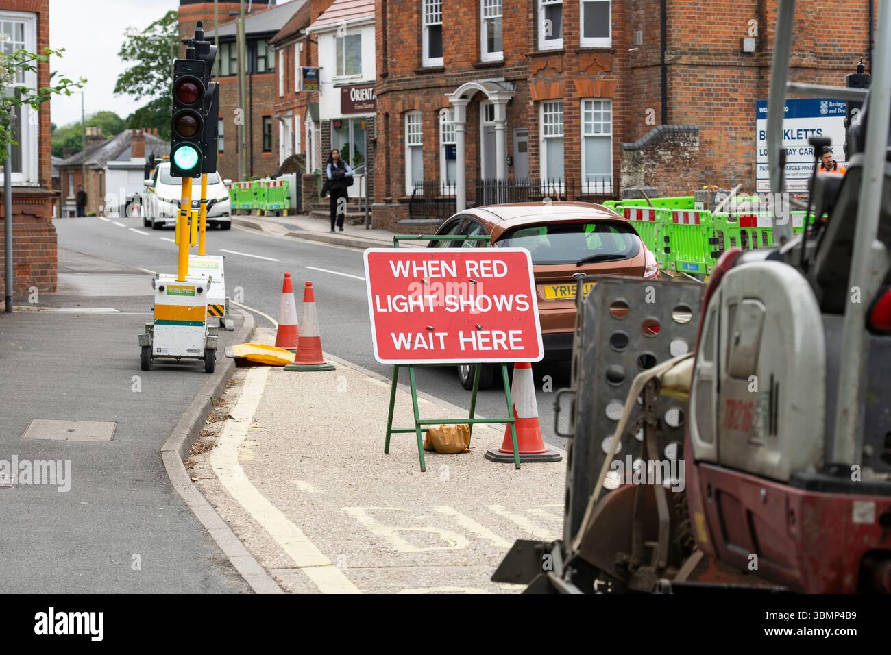When red light shows wait here instruction sign for traffic on ...