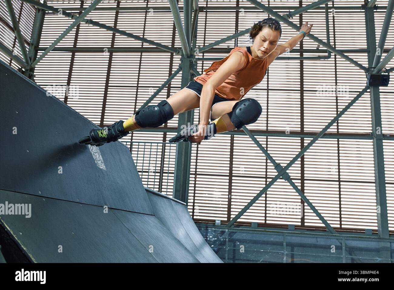 Extreme sport competition show. Rollerblader jump high from big air ...
