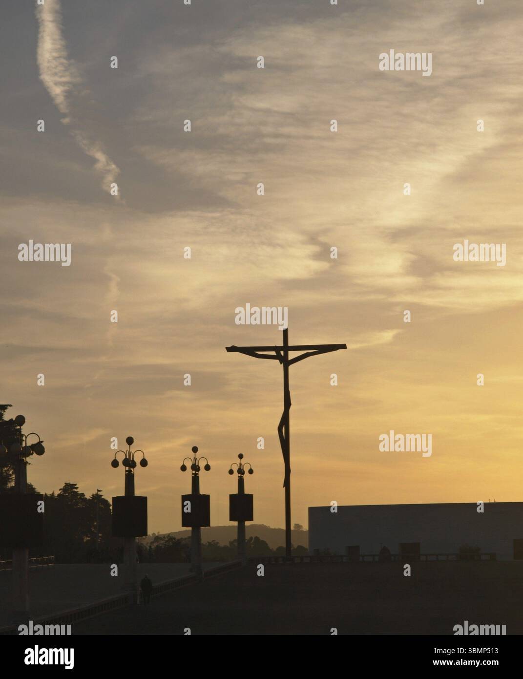 Silhouette of Sanctuary of Christ the King with large crucifix during ...