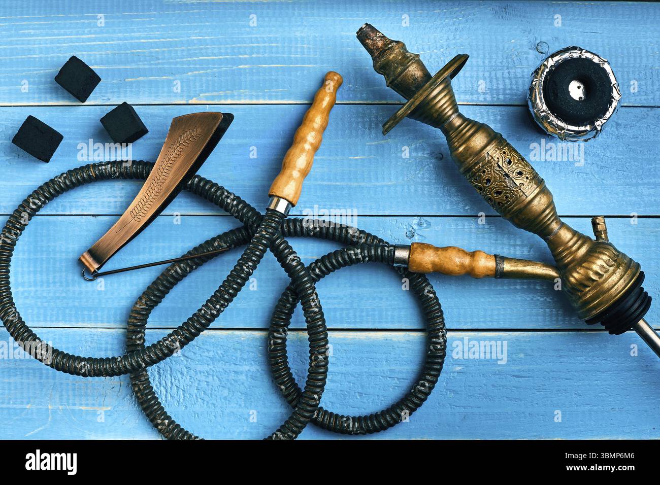 Parts of the hookah on blue wooden background. Hookah accessories. Top ...