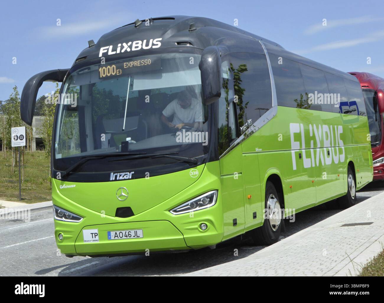 Green FlixBus Irizar i8 coach bus parked on sidewalk with driver ...