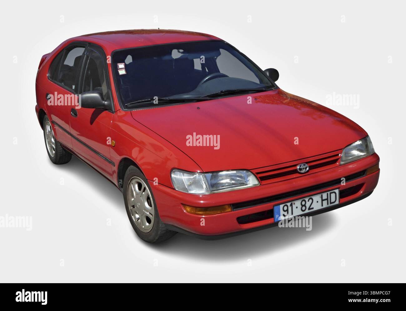 Red Toyota Corolla E100 parked showing its front on a white background ...