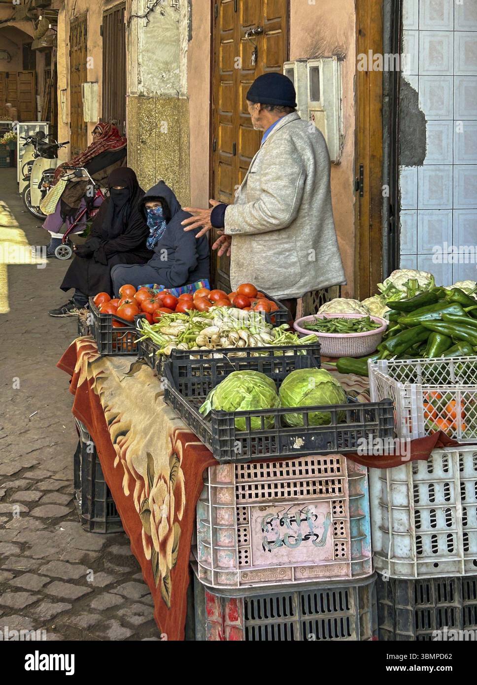 Moroccan street vendor selling fresh produce to local women in ...