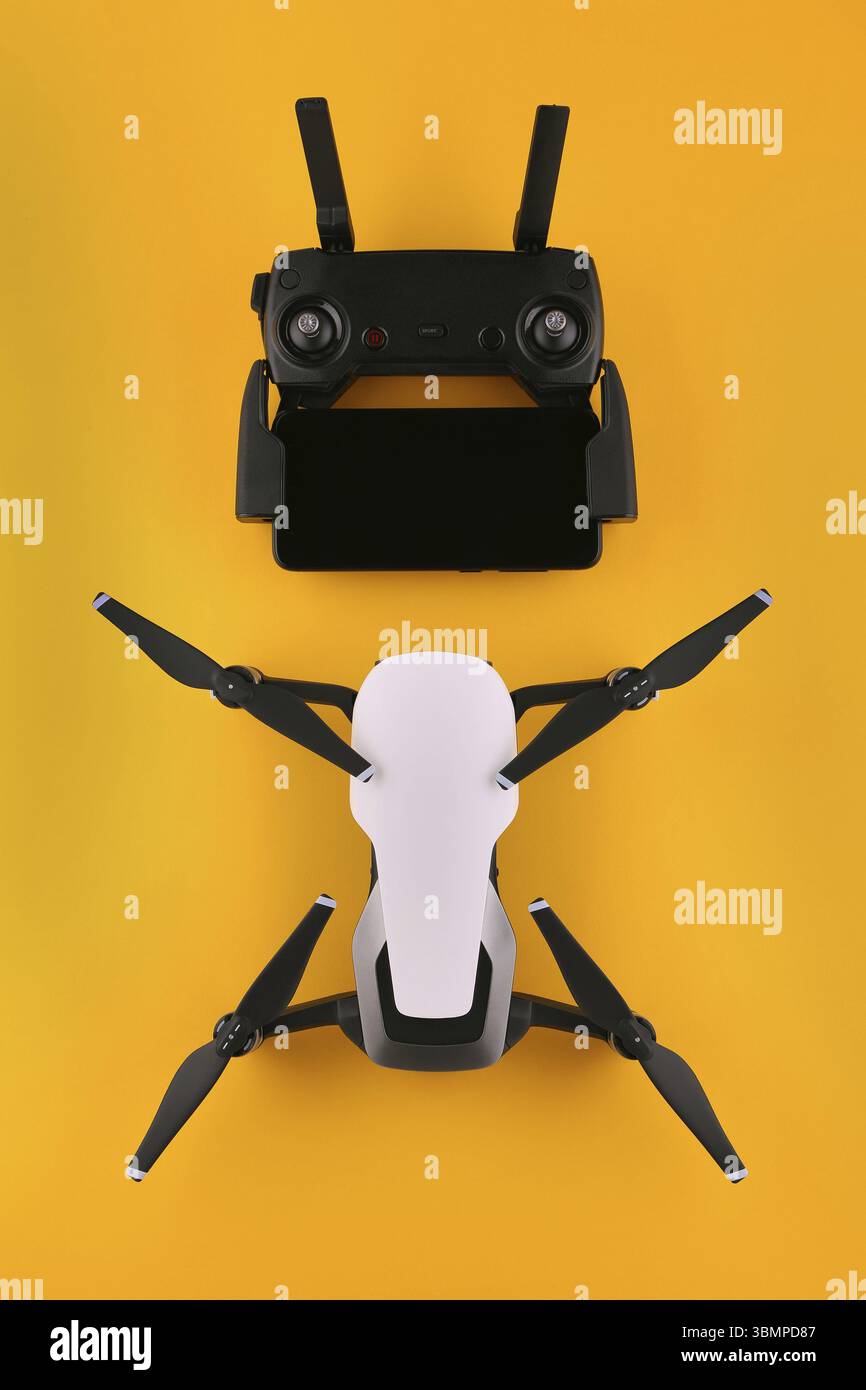 Drone quadcopter with a remote control and a smartphone is ready to fly ...