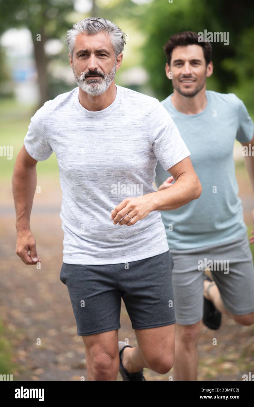 healthy people running on mountain trail Stock Photo - Alamy