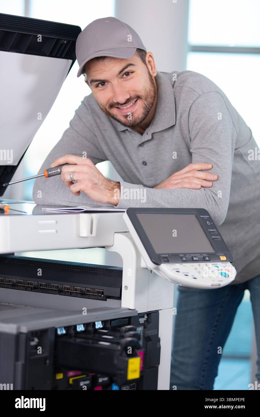 handyman fixing the office printer Stock Photo - Alamy
