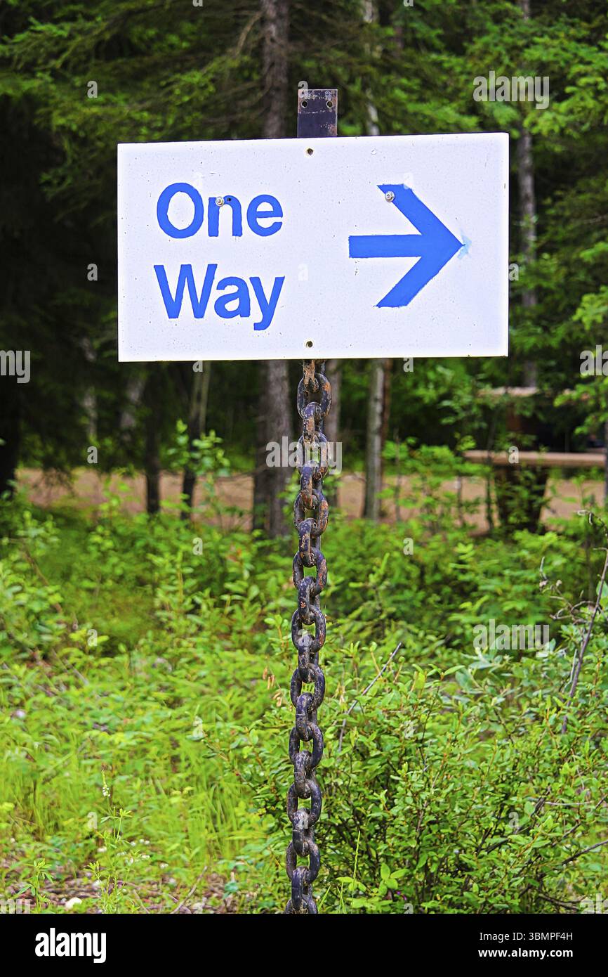 A one way sign with an direction arrow Stock Photo - Alamy