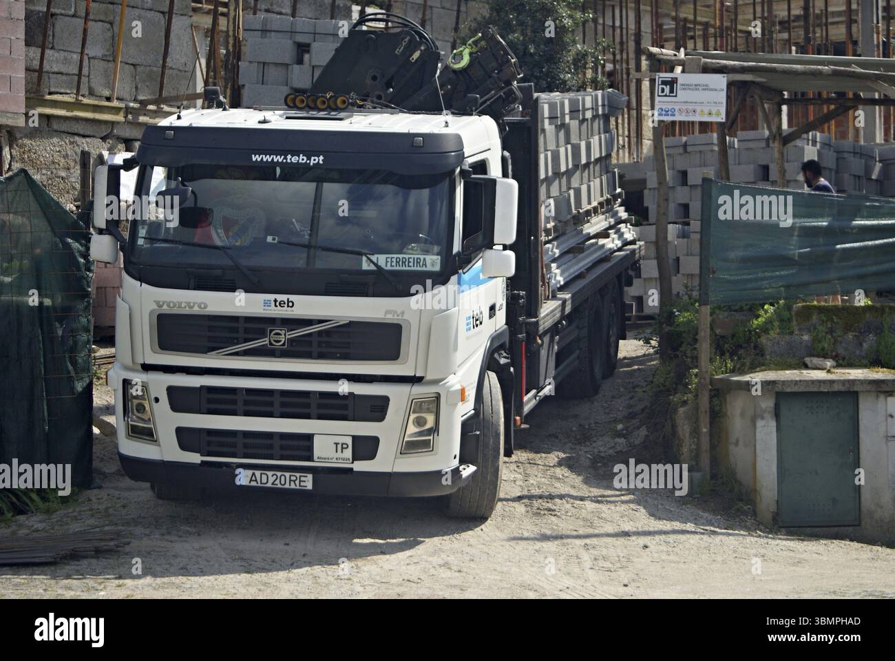 White Volvo FM truck transporting concrete blocks within a construction ...