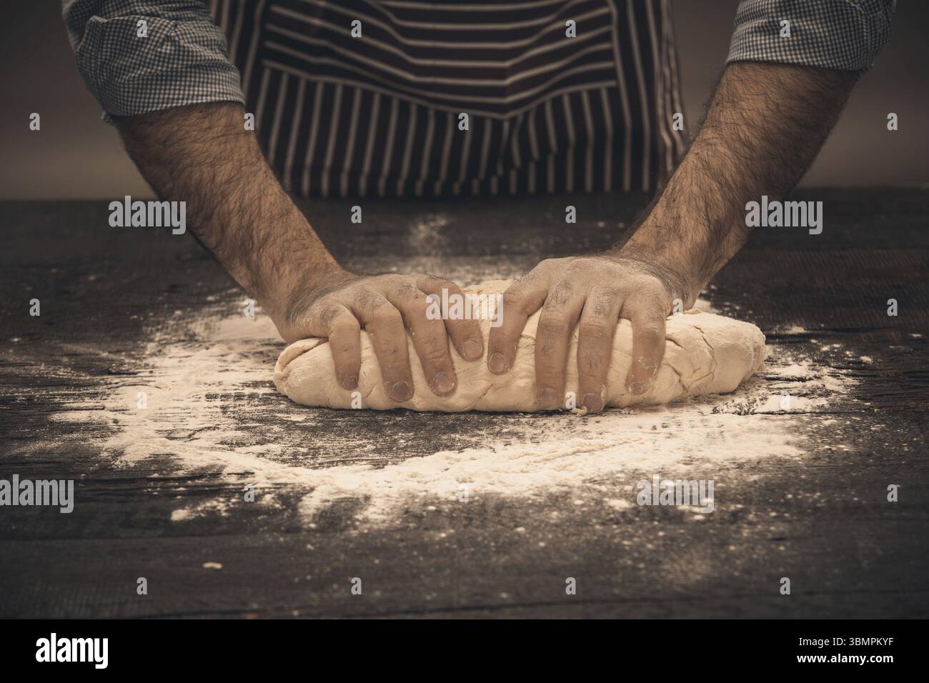 Male hands knead the dough. Chef cooking bread and bun Stock Photo - Alamy