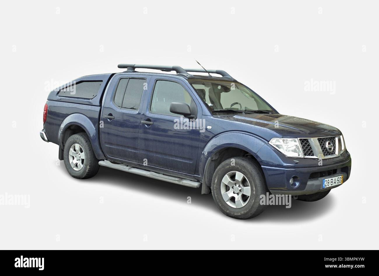 Dark blue Nissan four wheel drive pickup truck with roof rack and bed ...
