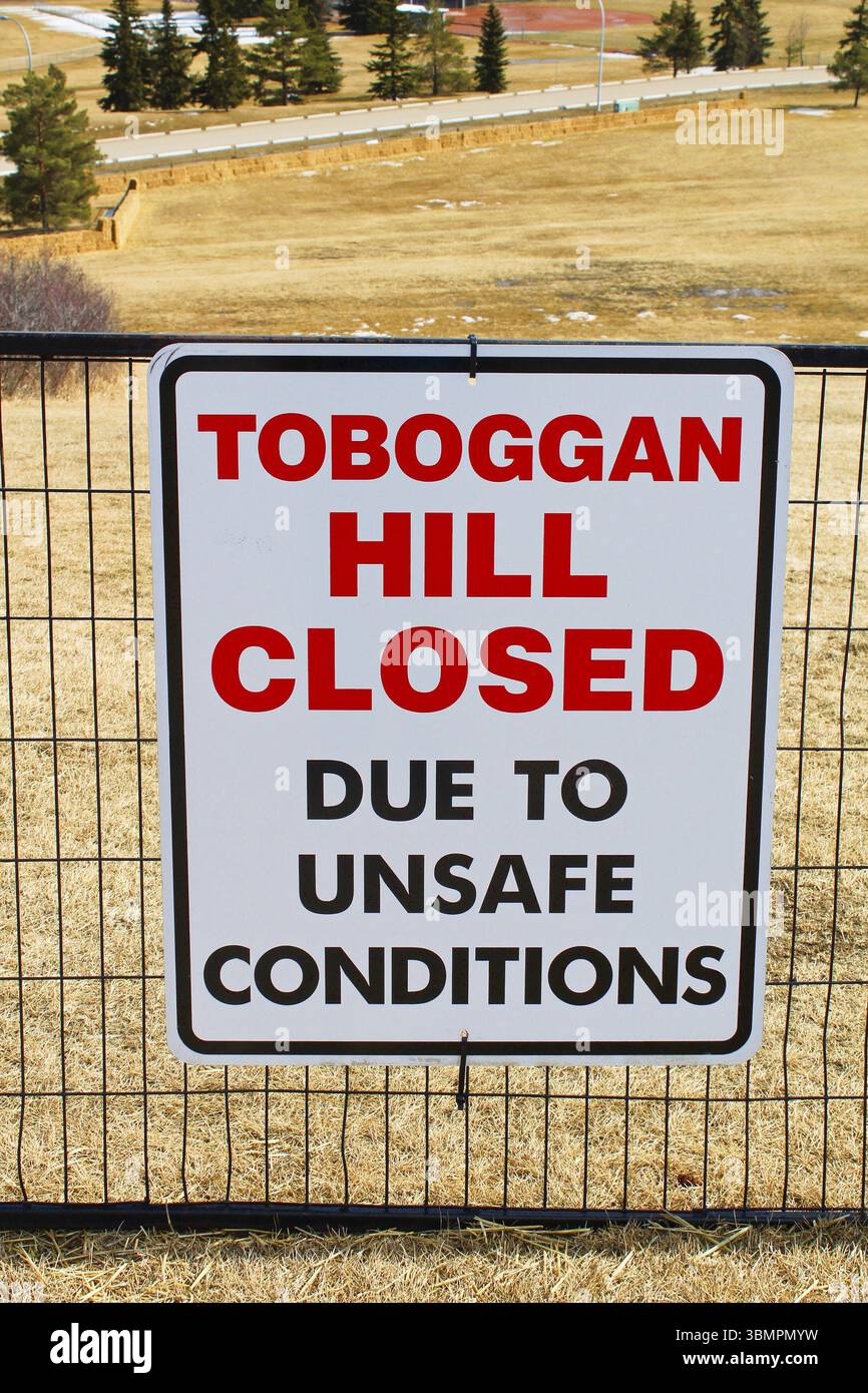 Toboggan hill closed sign posted in a public park once all the snow has ...