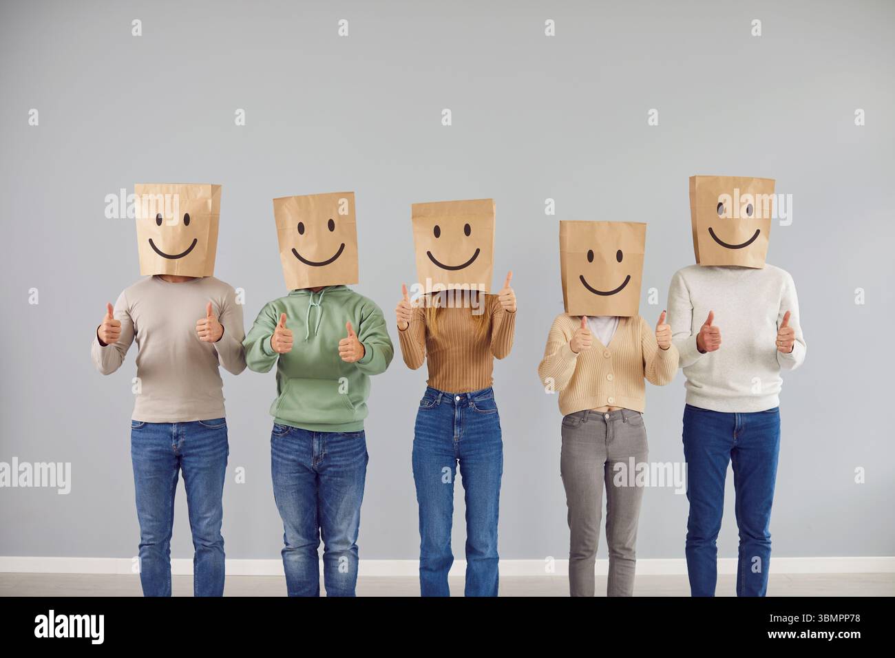 Faceless anonymous people standing in a row showing thumb up sign with ...