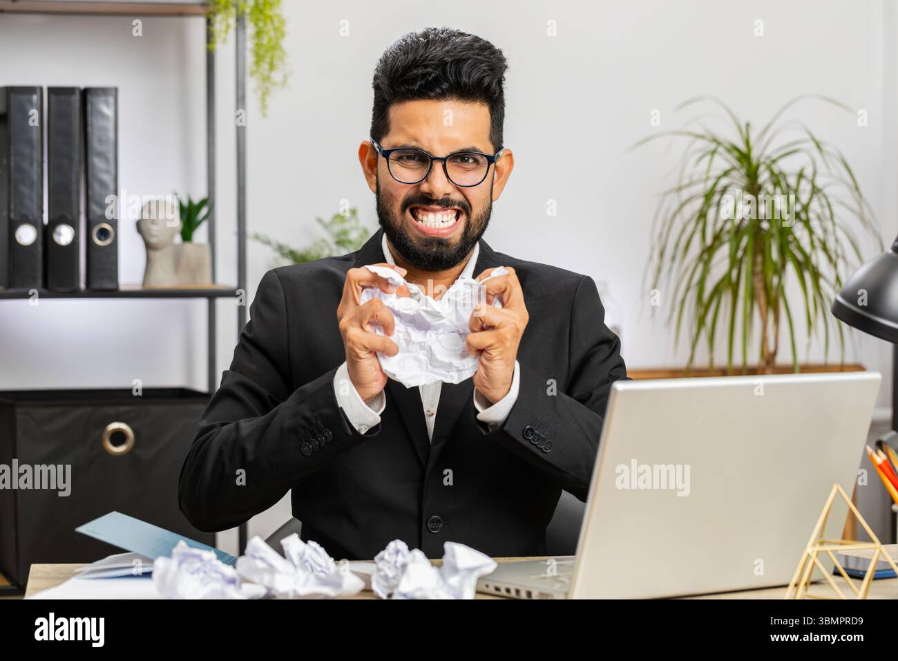 Angry furious Indian man working at office throwing crumpled paper ...