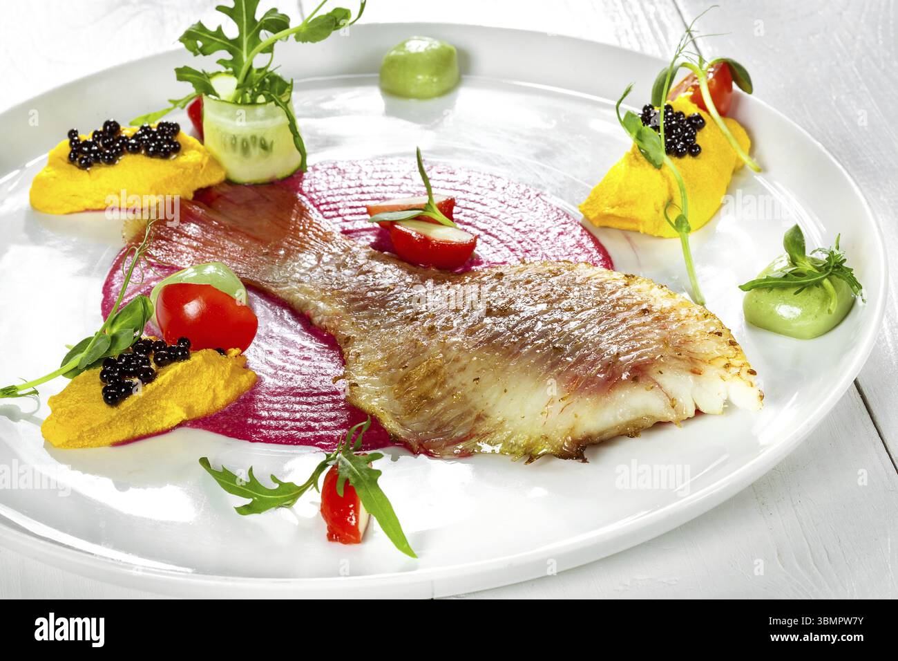 Fish dish - fried fish fillet and vegetables on a white plate. White ...
