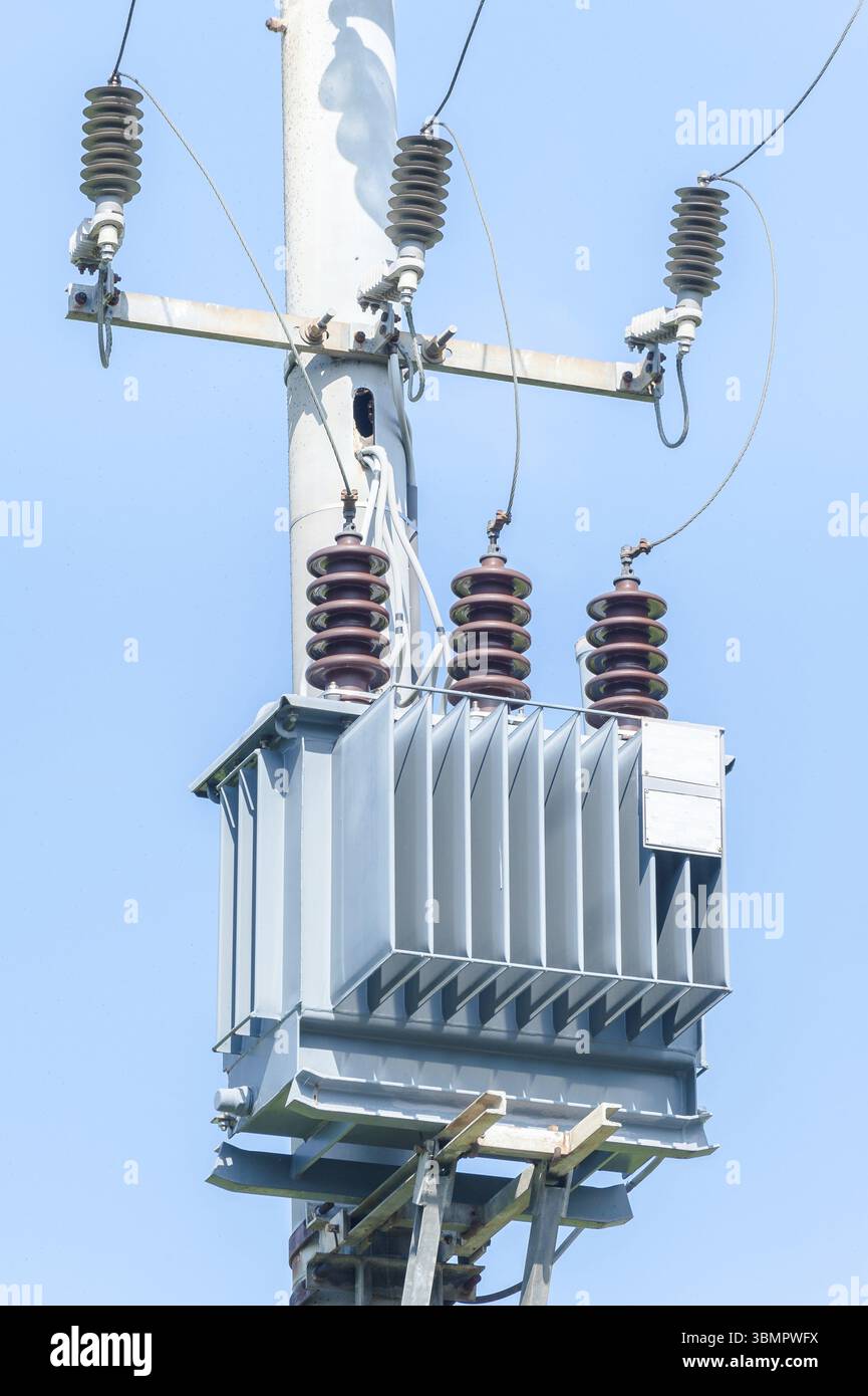 Electrical transformer of electrical pylon against the blue sky Stock ...