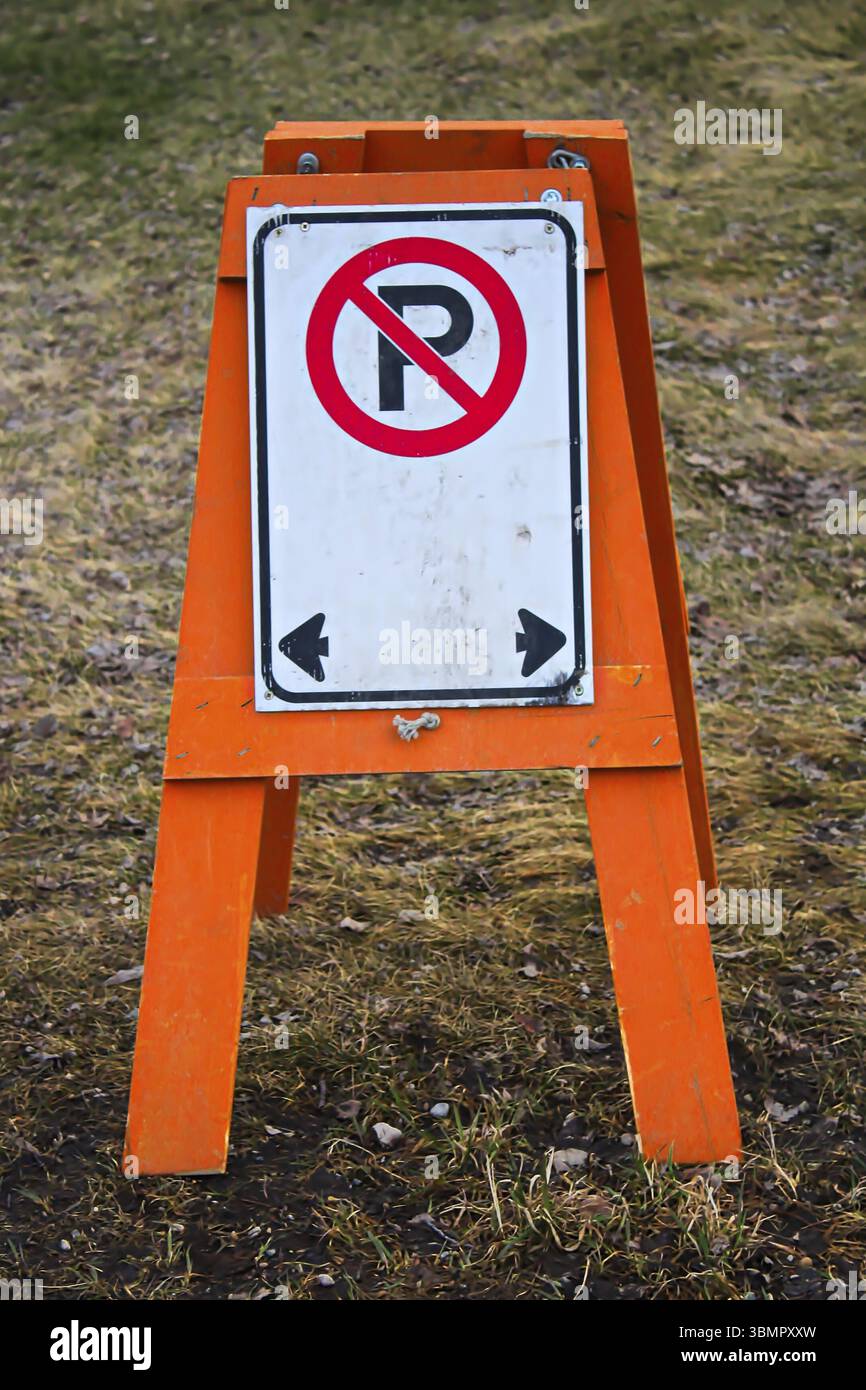 A temporary no parking barrier with right and left arrows Stock Photo ...