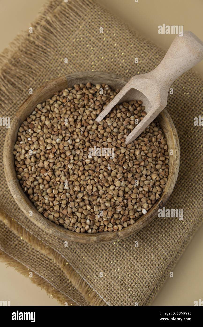 Raw buckwheat porridge in neutral beige background copy space. Whole ...