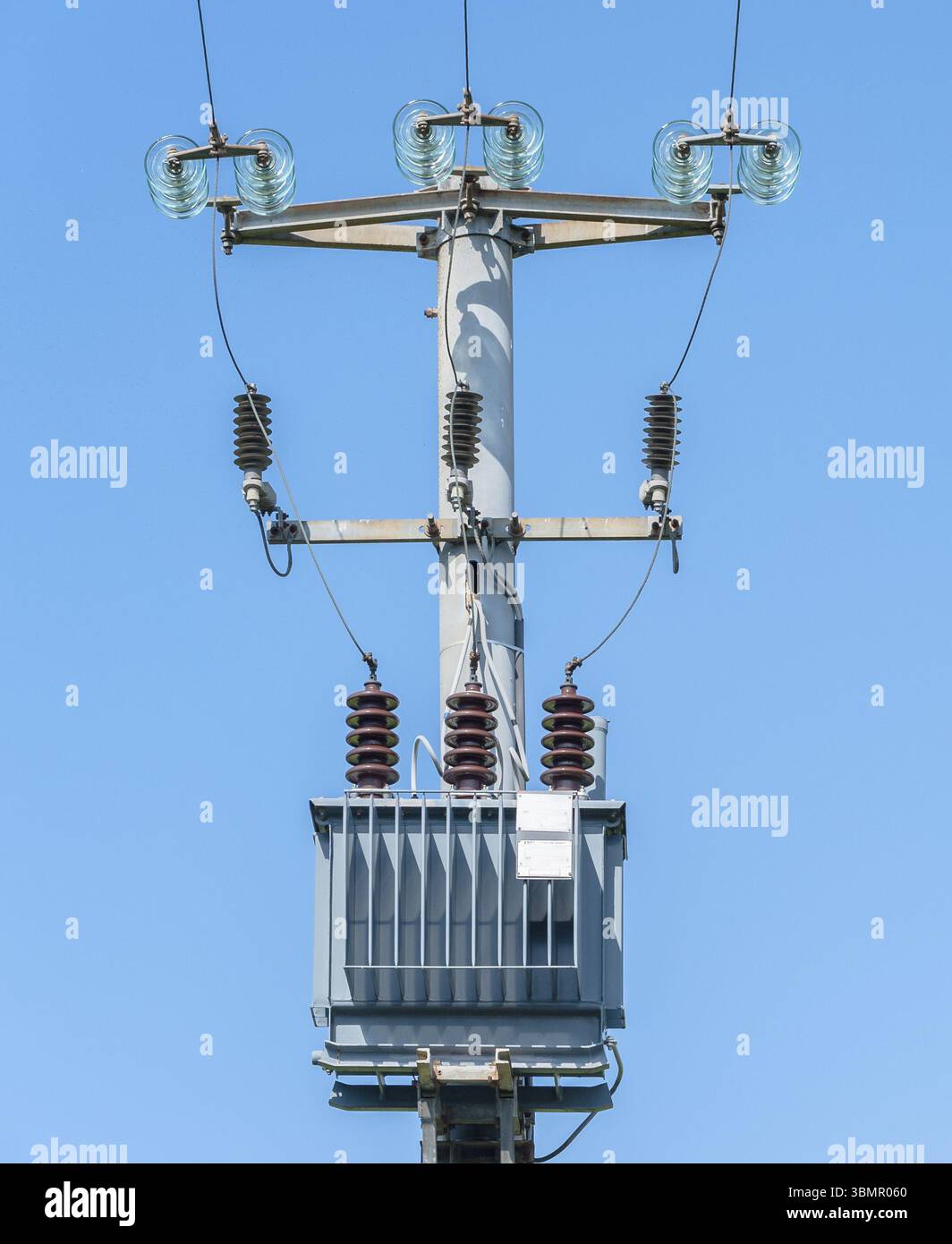 Electrical transformer of electrical pylon against the blue sky Stock ...