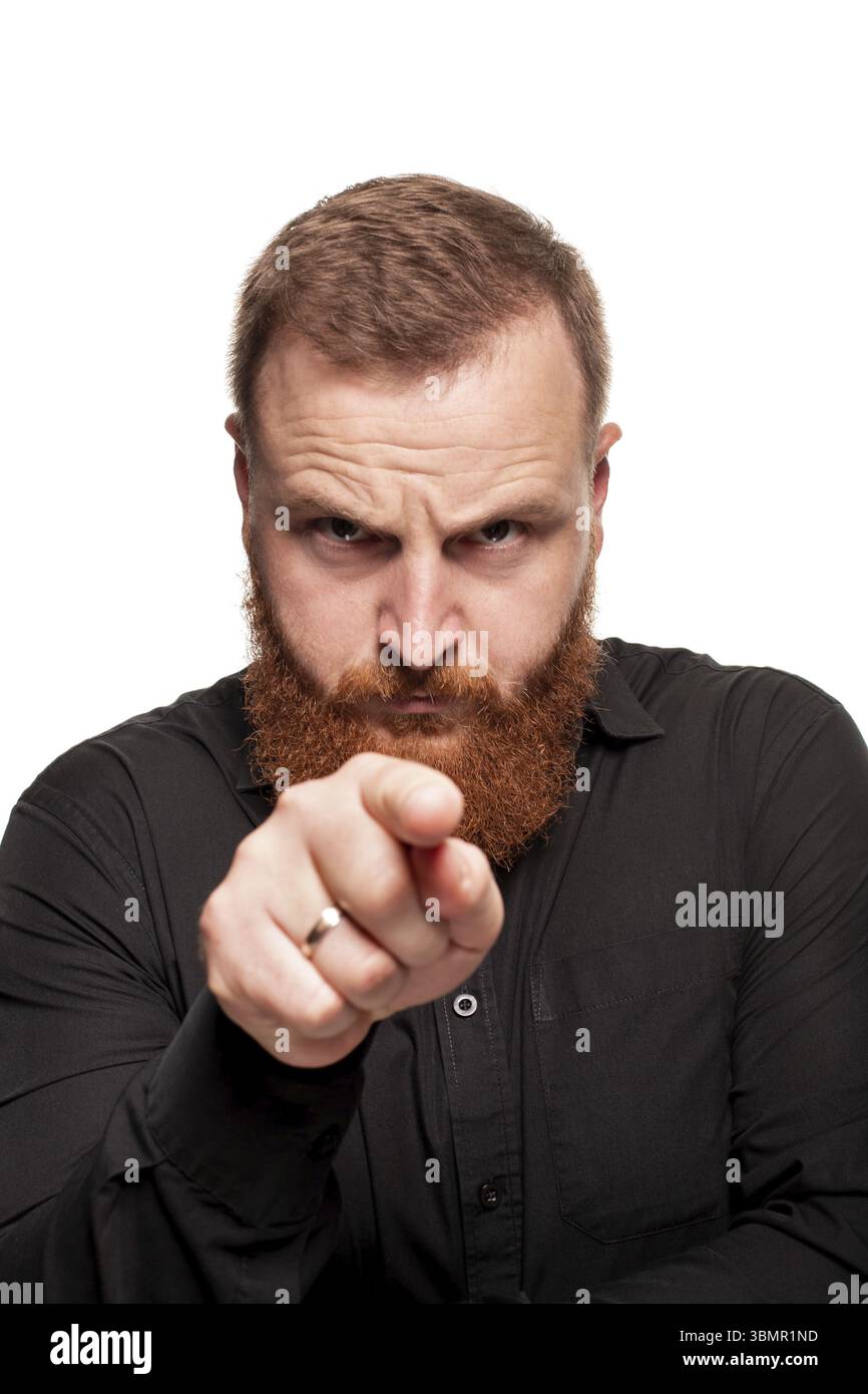 Portrait of a young, chubby, redheaded man with a beard in a black ...