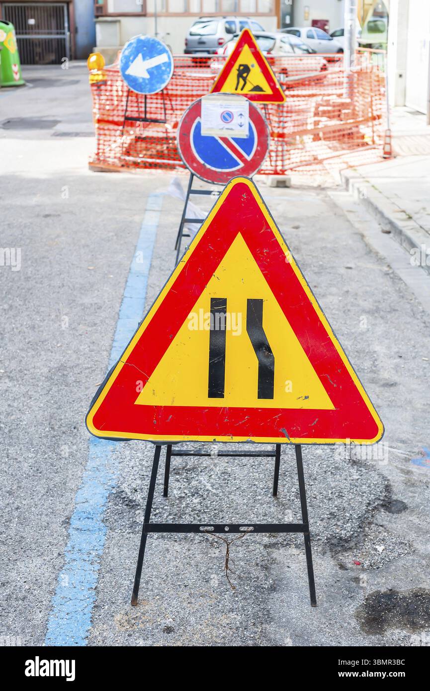 Road sign lane narrowing. In the background, blurred a roadworks Stock ...