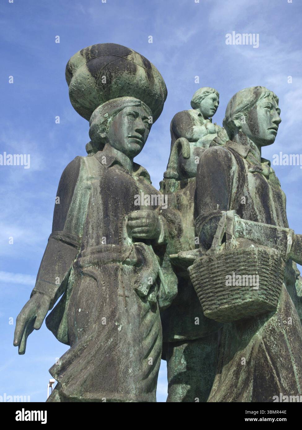 Bronze statue representing a family of refugees escaping war or poverty ...