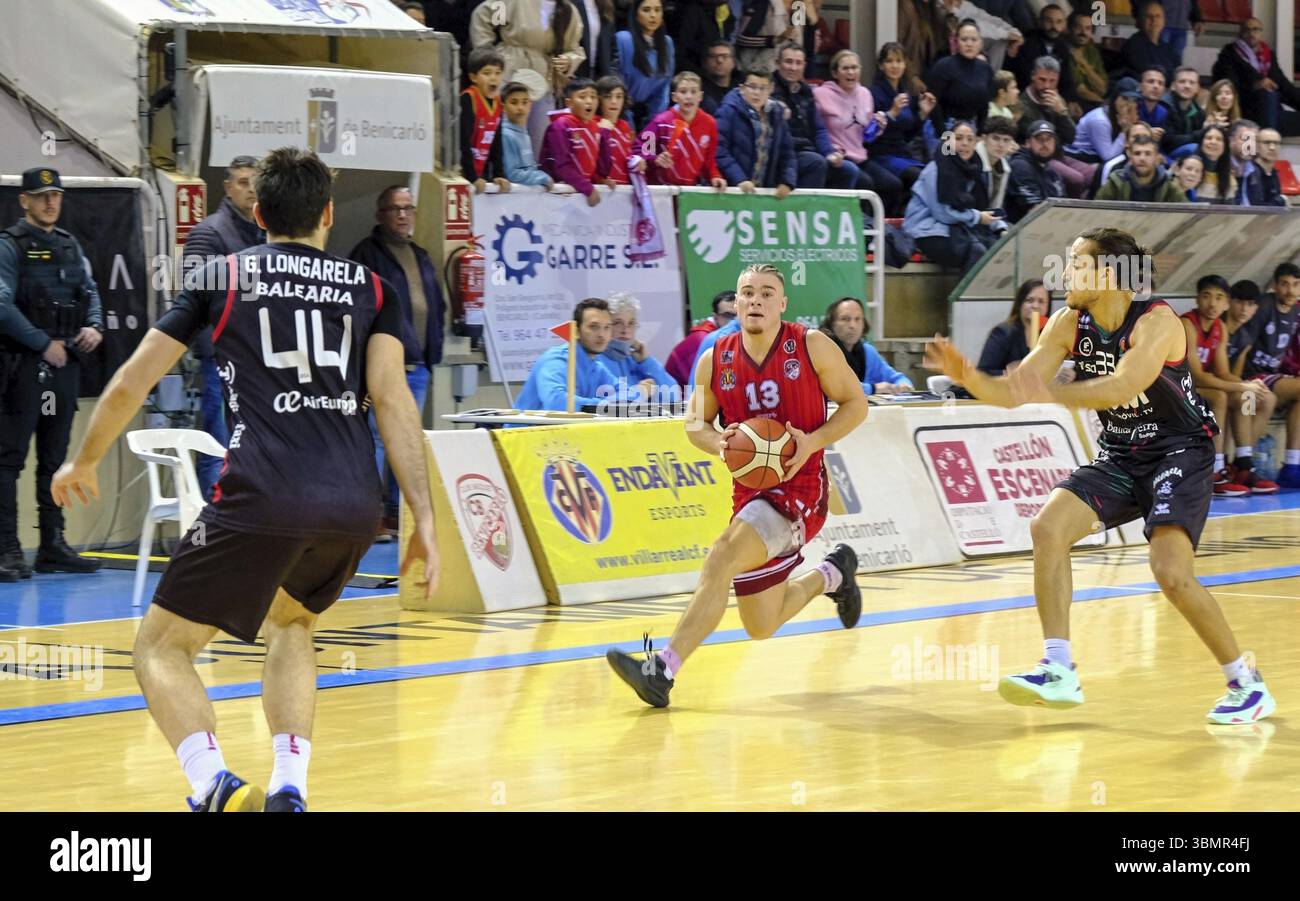 Basketball player running and dribbling during a match, other players ...