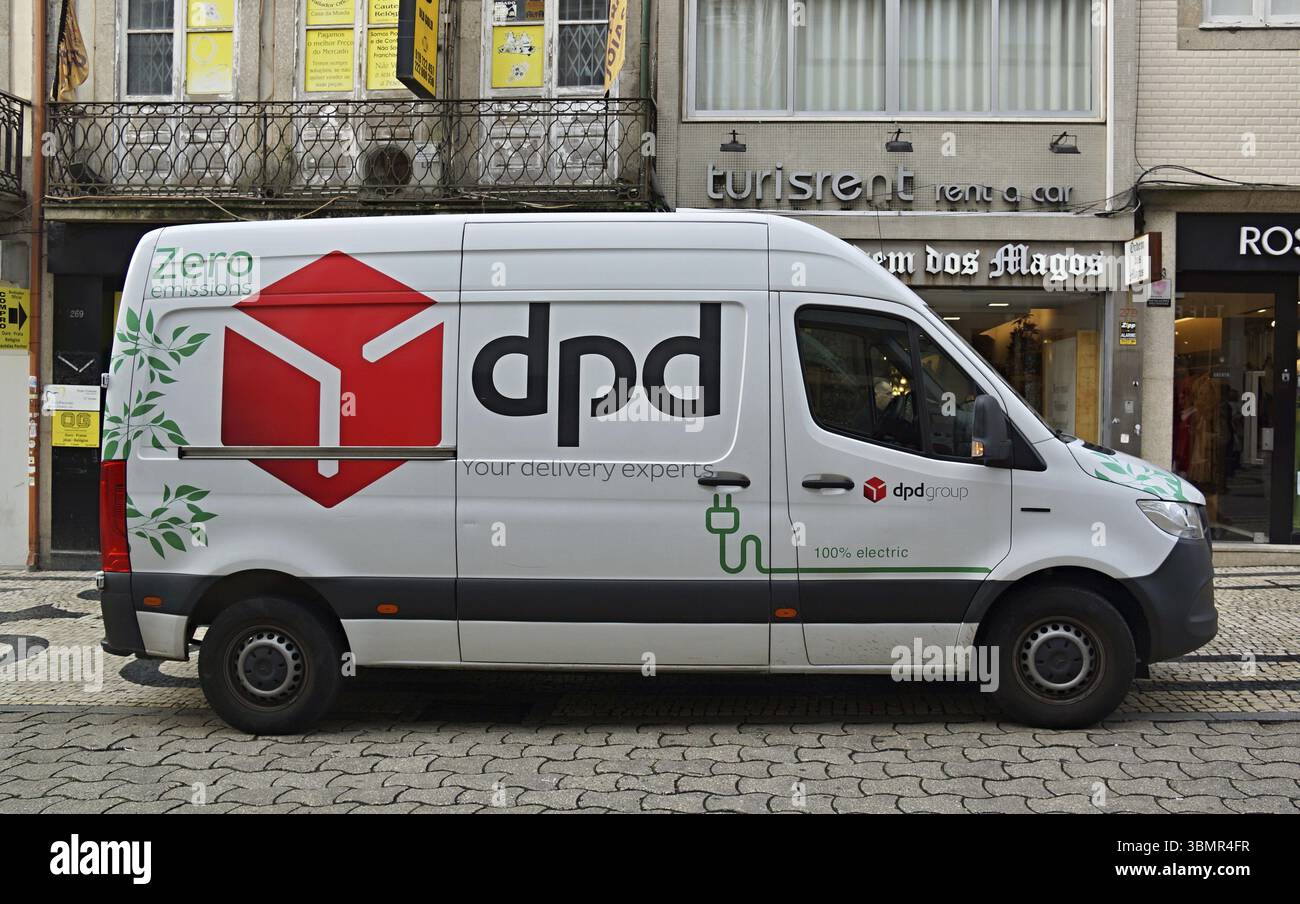 White DPD delivery van parked on a cobbled street, showcasing its ...