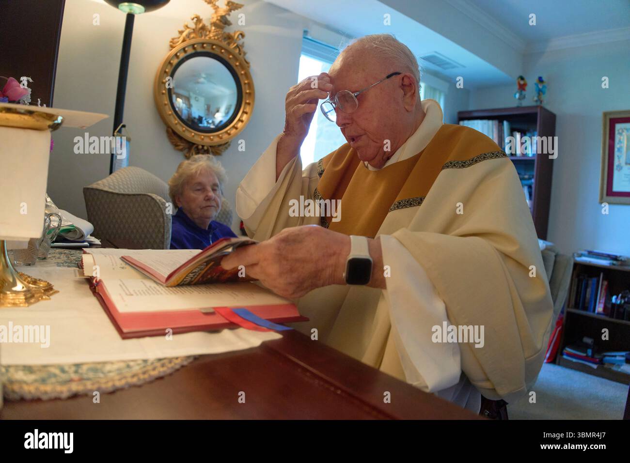 The Rev. James Kelly celebrates Mass at his apartment in the Normandy ...
