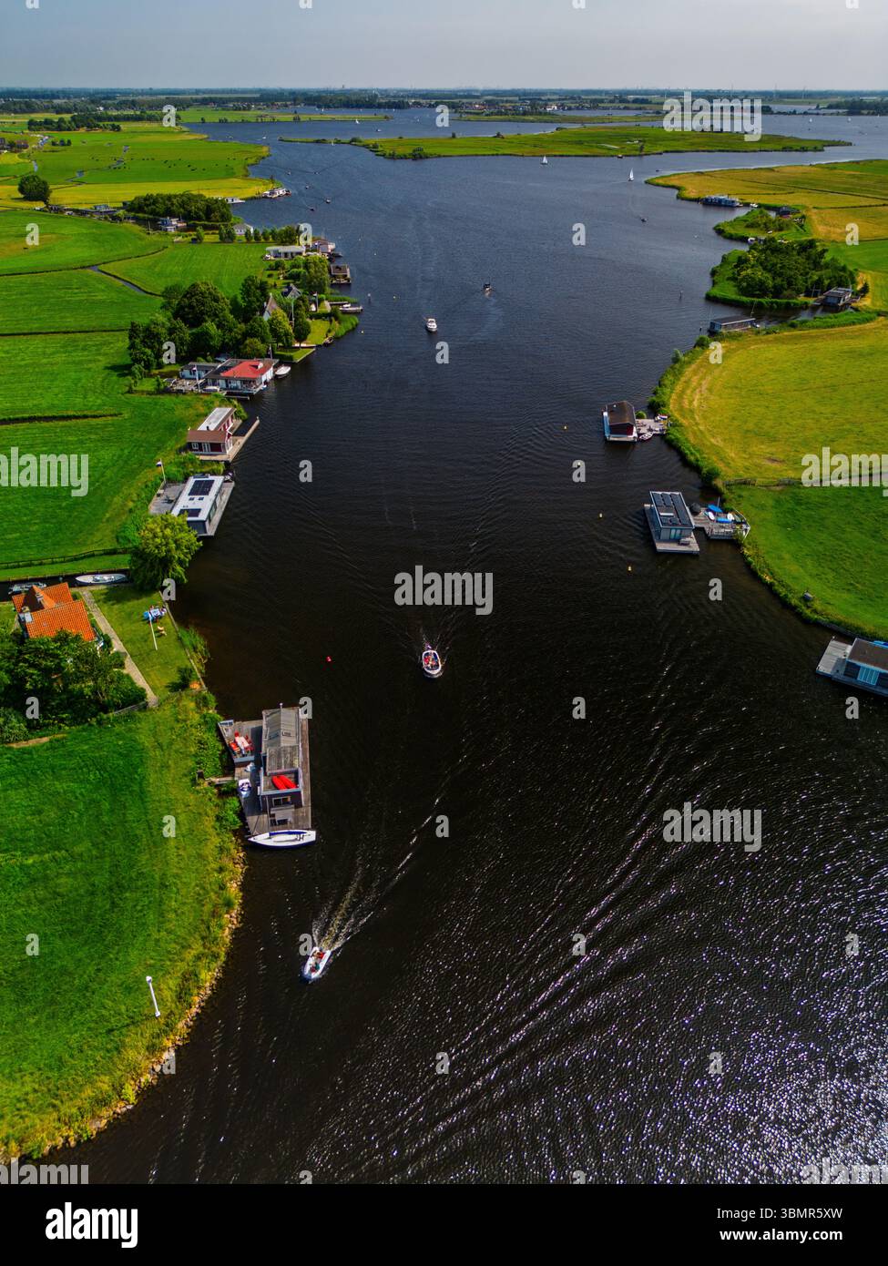 A top-down view of a marina with multiple boats docked along wooden ...