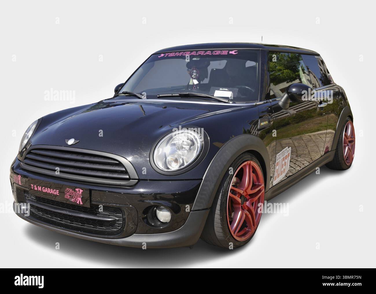 Tuned Mini Cooper showcasing aftermarket modifications, including pink ...