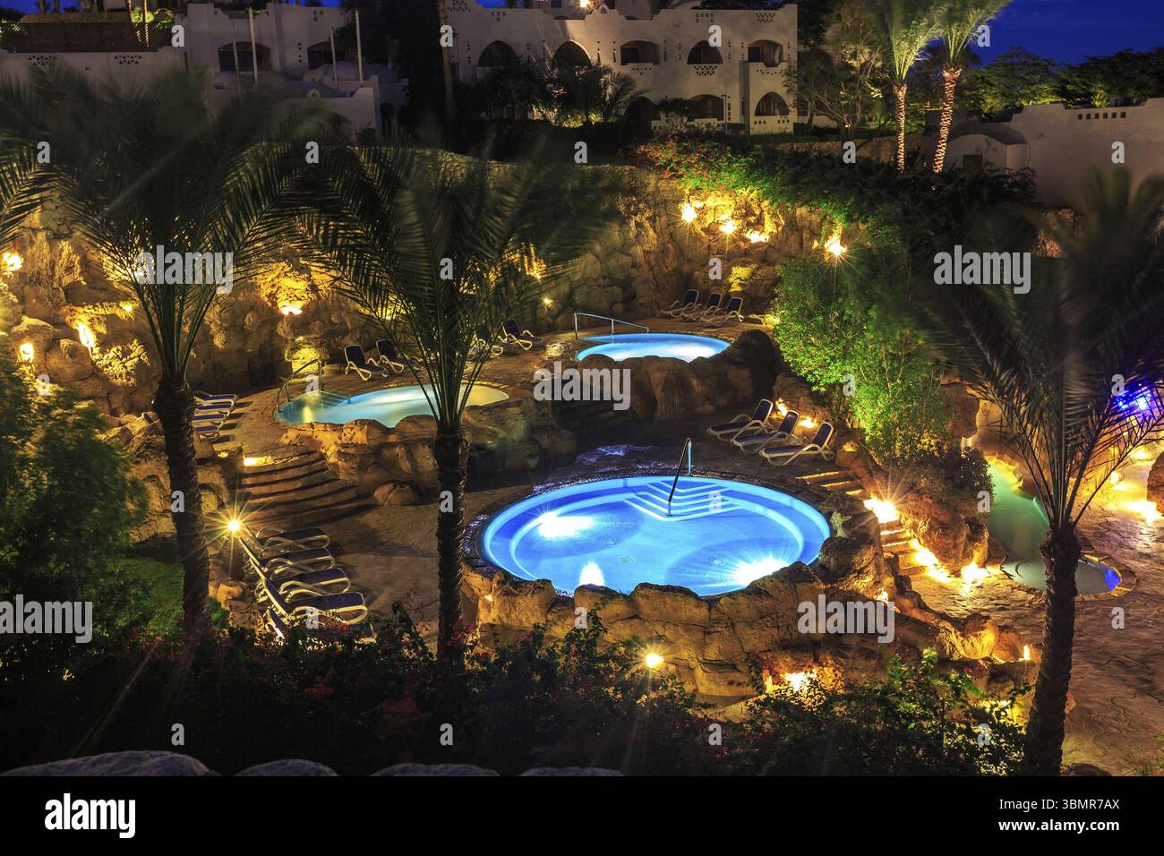 Evening view for luxury swimming pools in night illumination on a ...