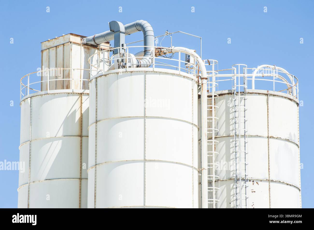 White silos for the storage of lime and cement Stock Photo - Alamy