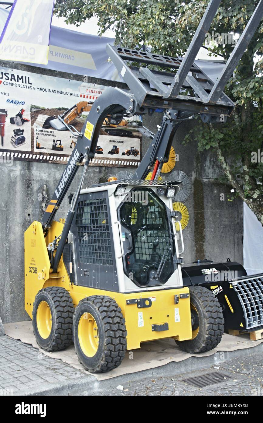 Yellow and gray Liugong 375b skid steer loader parked with forks raised ...