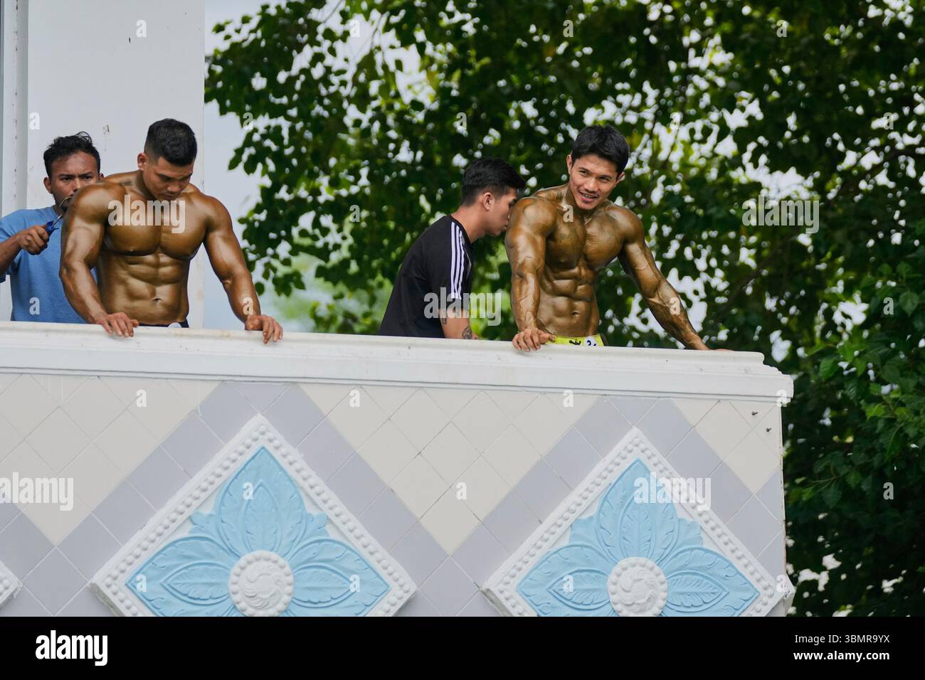 Contestants prepare at backstage during their bodybuilding competition ...