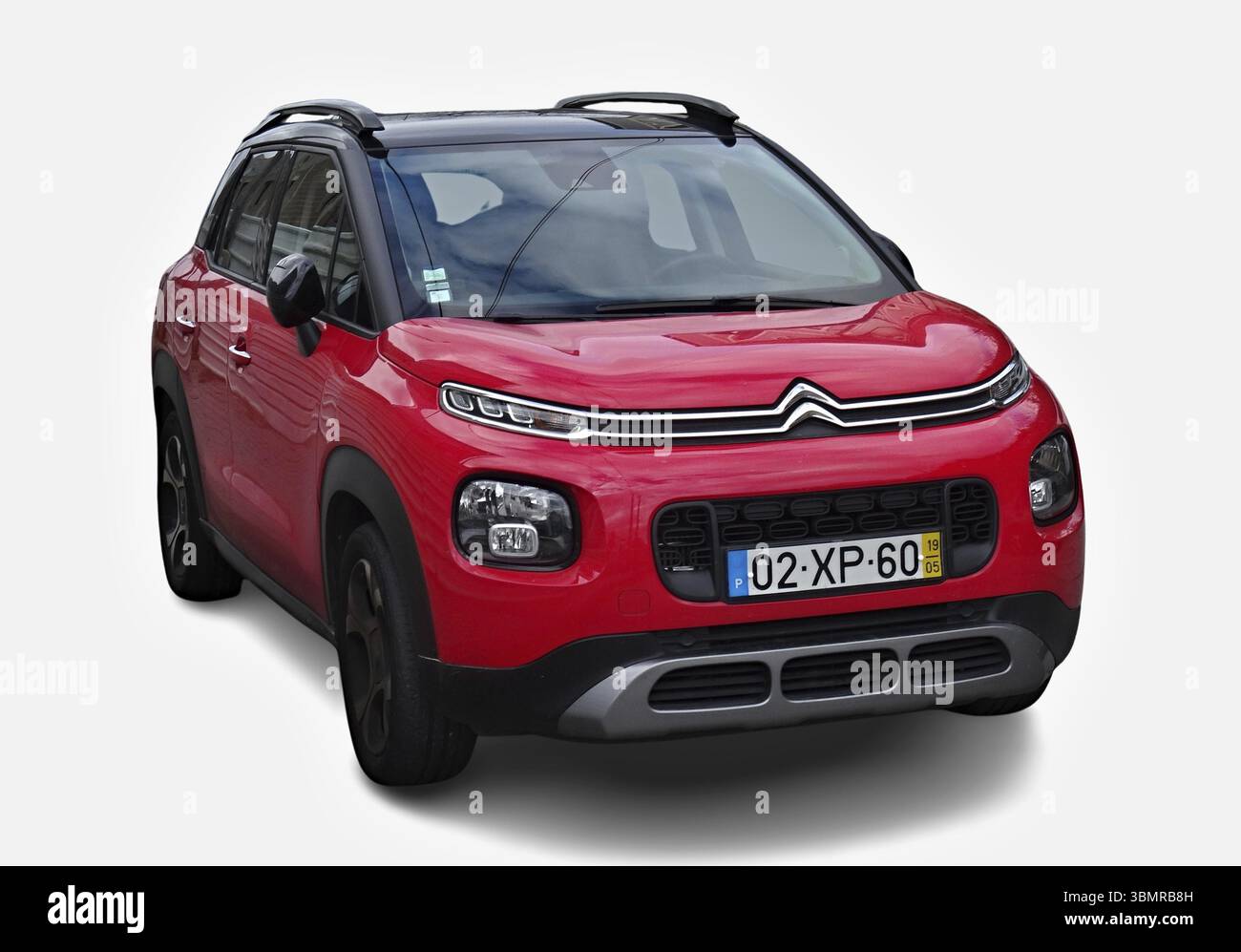 Modern red Citroen C3 Aircross, a compact SUV, parked against a white ...