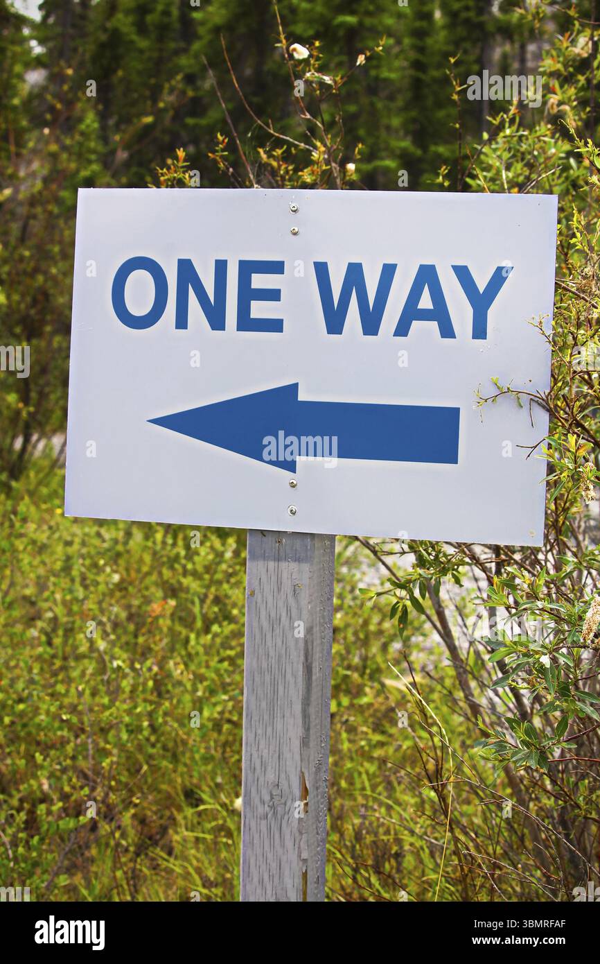 A one way sign with an direction arrow Stock Photo - Alamy