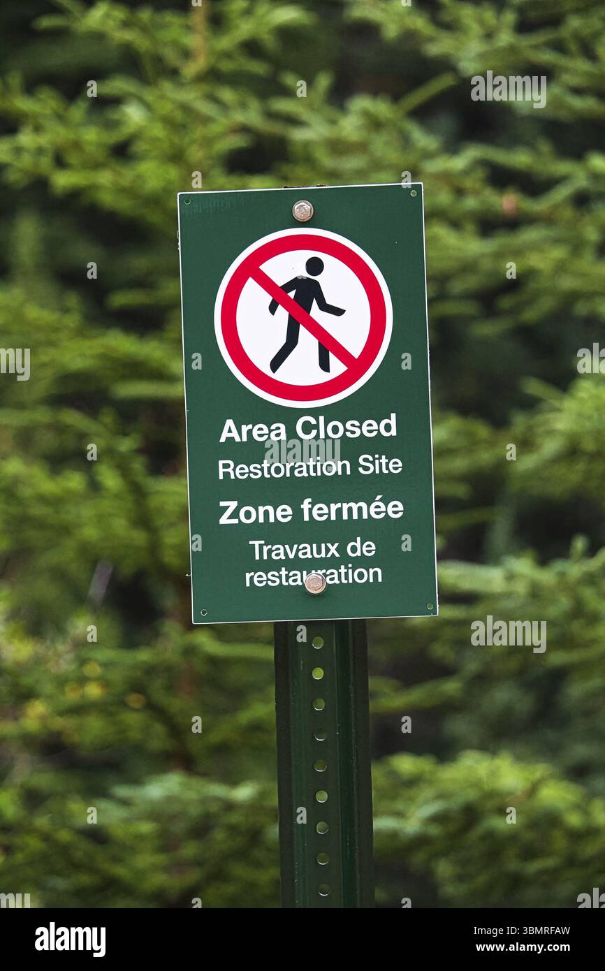 A green sign indicating area closed as a restoration site Stock Photo ...