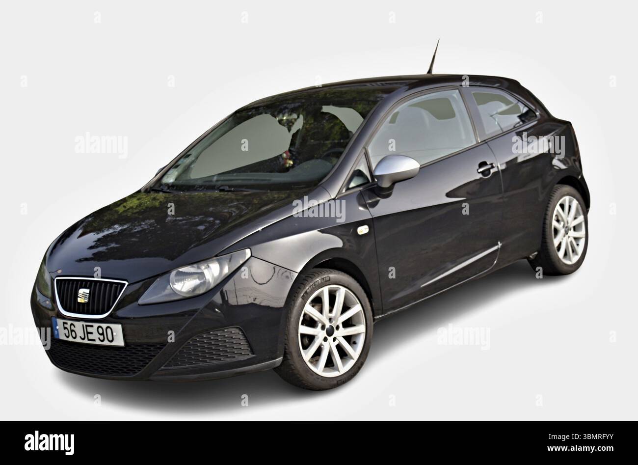 Dark gray SEAT Ibiza with alloy wheels parked, showing its front and side, isolated on white ...