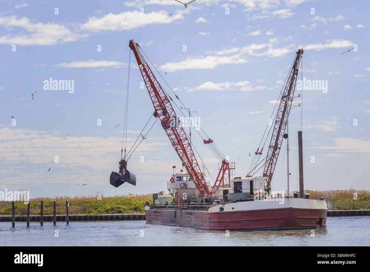 Dredger ship navy working to clean a navigation channel Stock Photo - Alamy