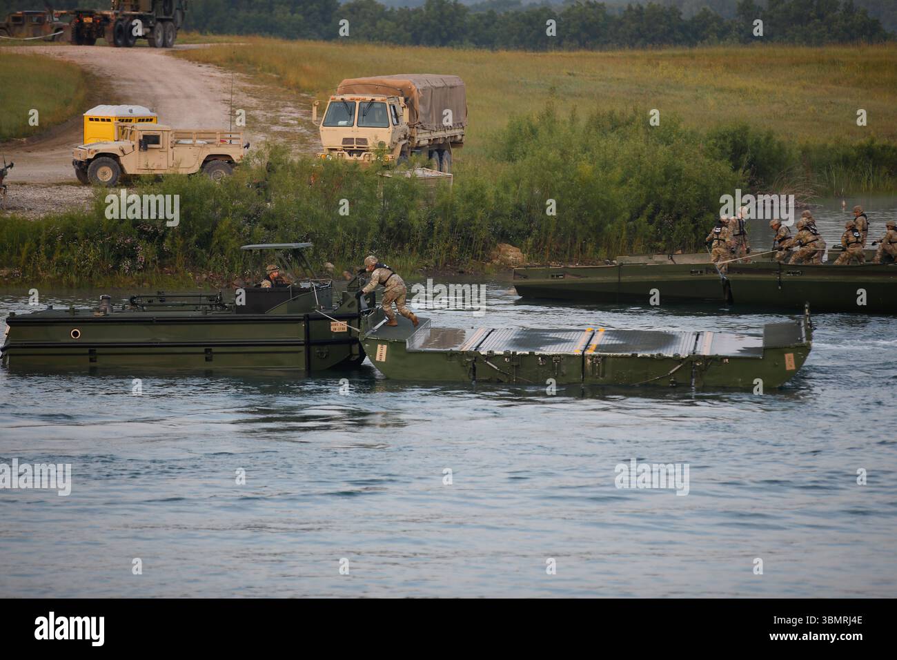 U.S. Army National Guard soldier attaches a bridge bay to a Bridge ...
