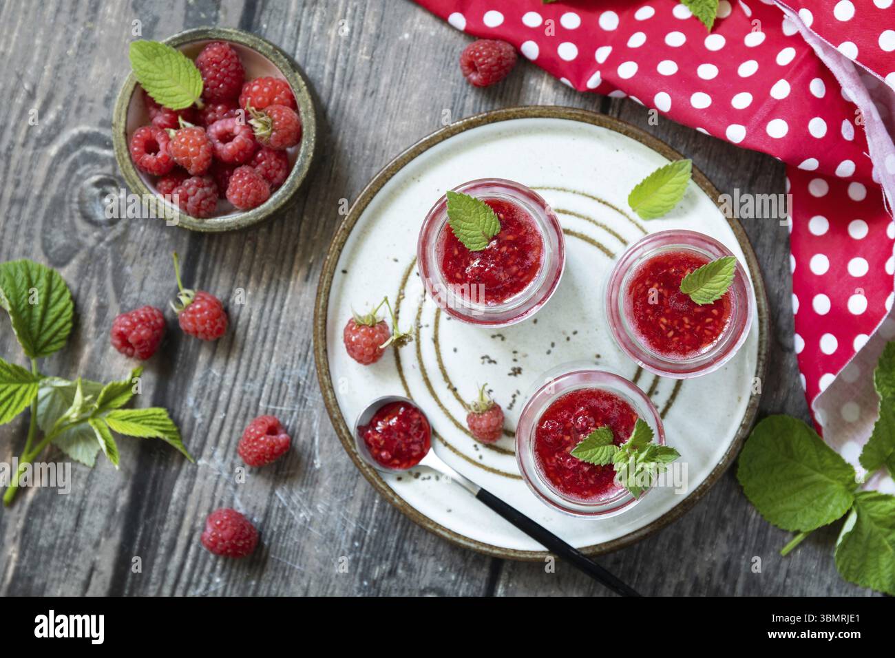 Healthy breakfast. Glass jars with chia pudding with raspberry and jam ...