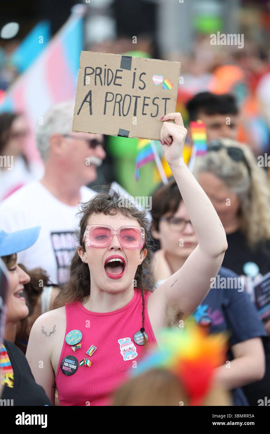 An activist holds a sign, while taking part in the Dublin Pride parade through the city centre ...
