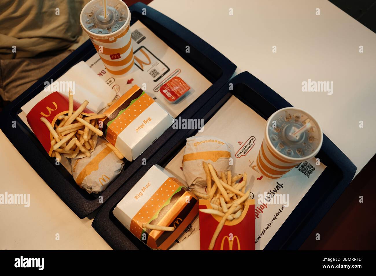 Top view of two fast food trays with McDonald's Big Macs, cheeseburgers ...