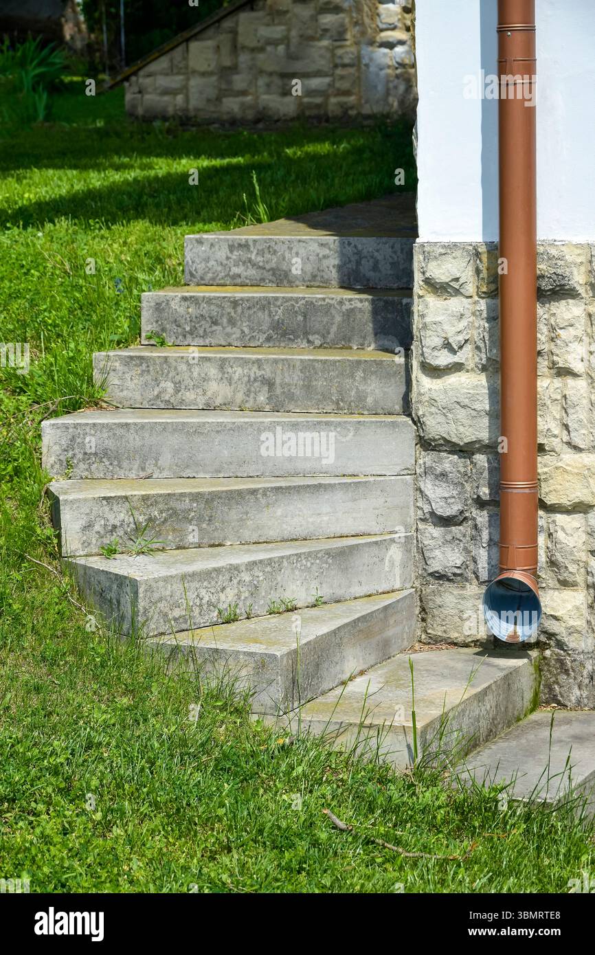 Original corner staircase with concrete steps around corner of large ...