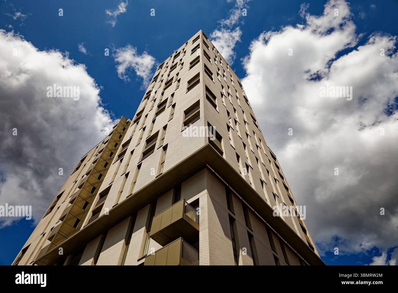 A white tower block soars above Cambridge Street in a sunny Manchester ...