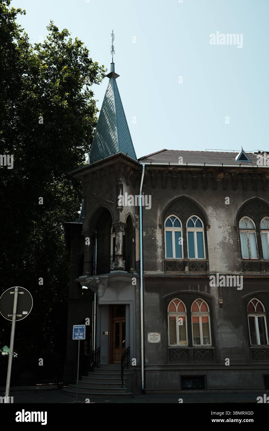 A charming old house with a pointed turret and arched windows, partly ...