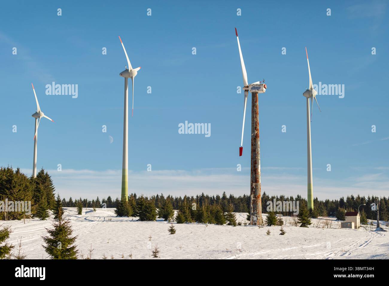 Wind turbines on a snowy mountain plateau in Neklid, Czech Republic ...
