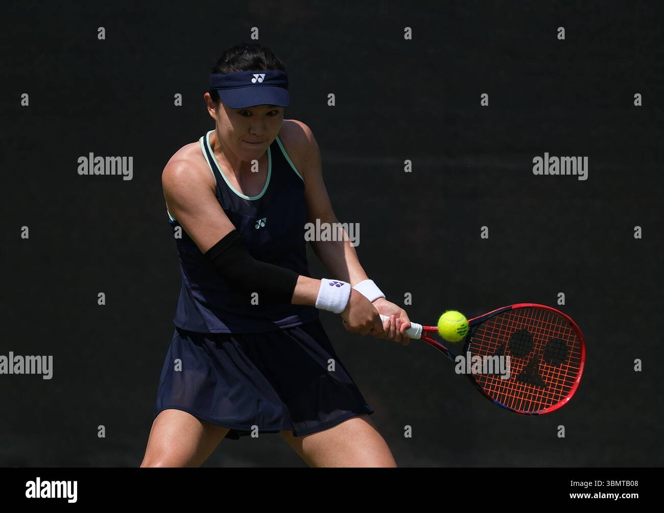 Lin Zhu plays a backhand shot to McCartney Kessler (not in view) during ...