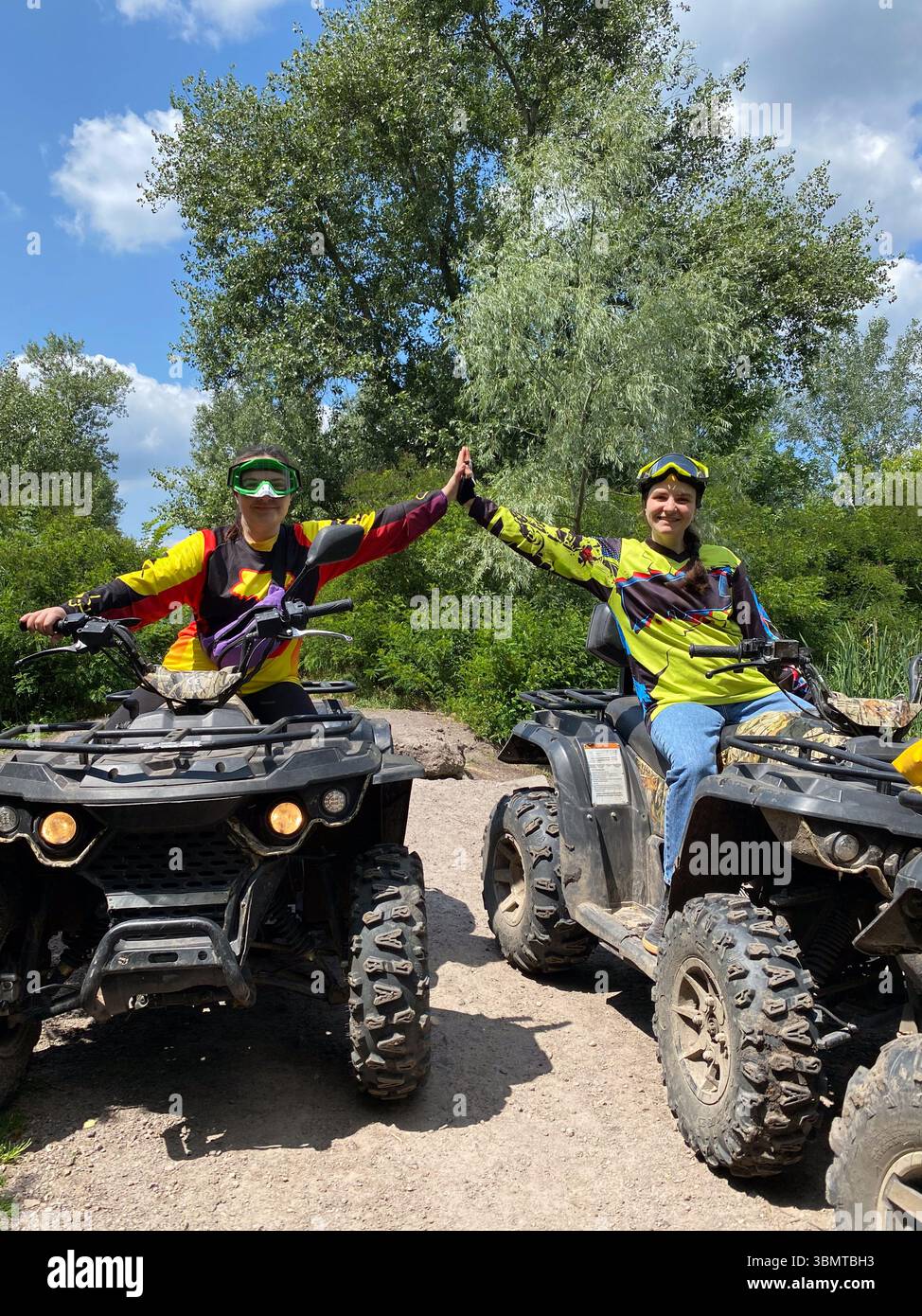 Quad bike ride on dirt roads in nature, vertical shooting Stock Photo ...
