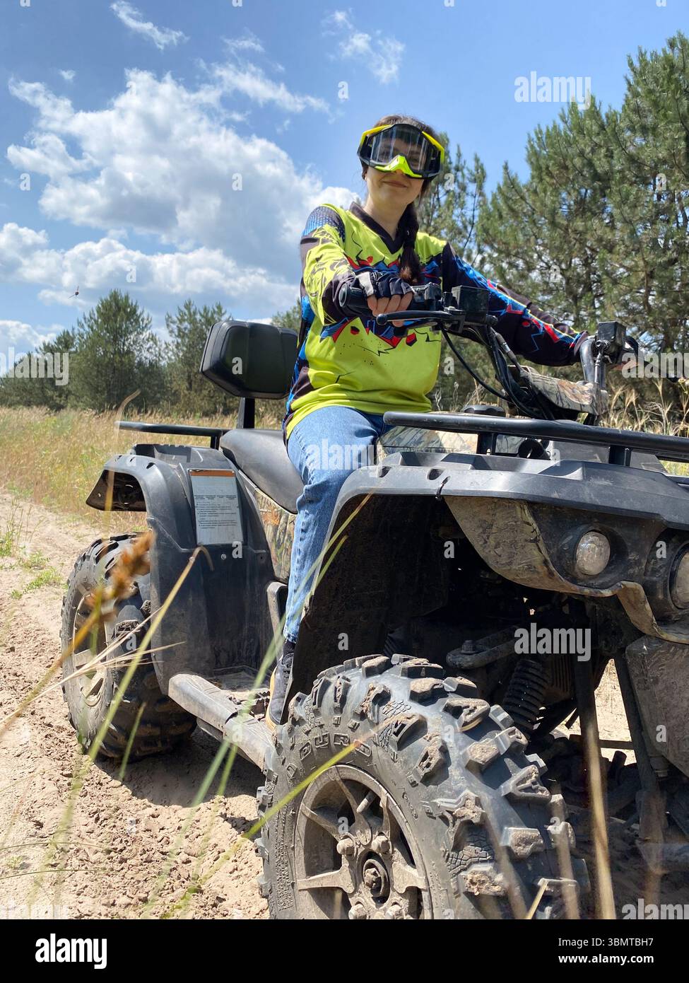 Quad bike ride on dirt roads in nature, vertical shooting Stock Photo ...